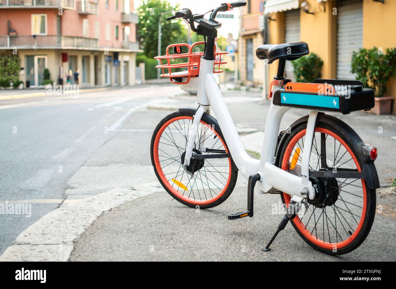 Electric bike for rent parked on street for eco use by mobile phone ...