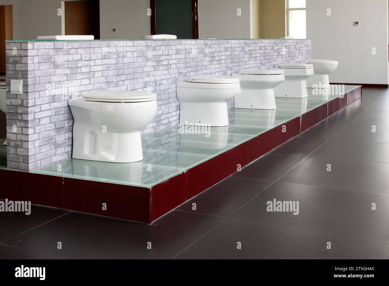 Ceramic toilet display in a hall, closeup of photo Stock Photo - Alamy