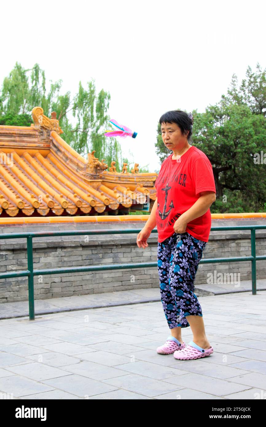 BEIJING - MAY 23: lady was kicking shuttlecock in the Beihai Park，on ...