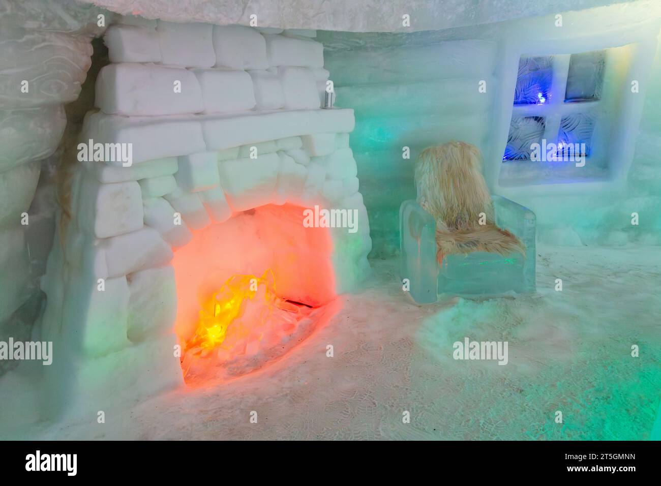 glowing fire and chair ice sculptures inside the Snowhotel Ice Hotel at ...