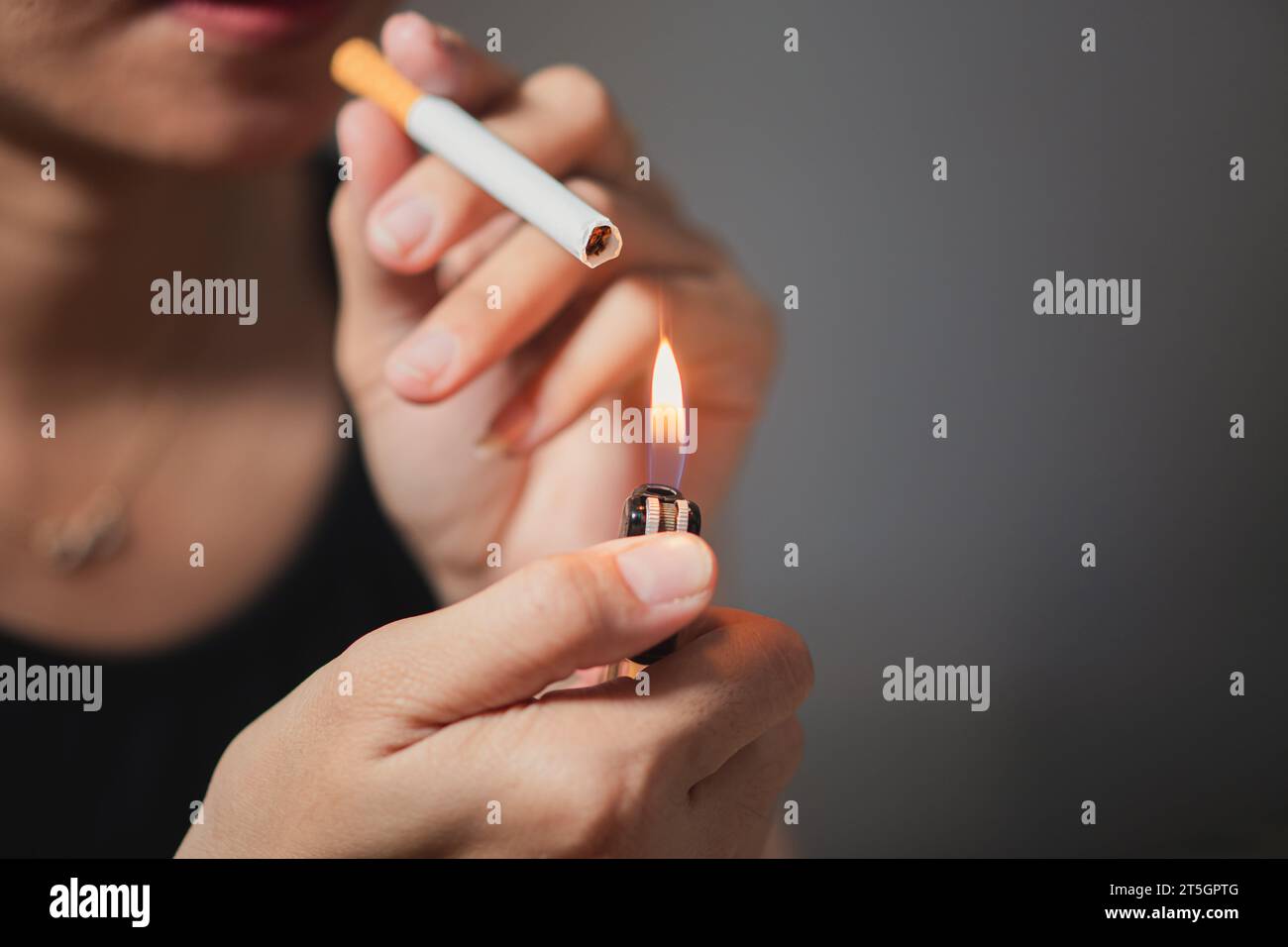 Smoker lighting a cigarette with lighter Stock Photo - Alamy