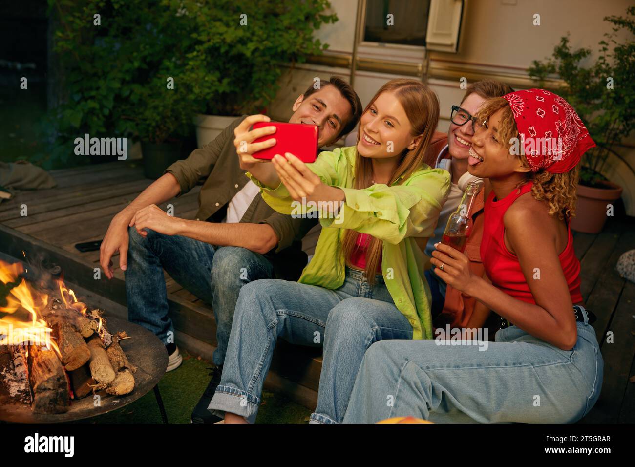 Friends taking selfie at picnic having fun together during motor home ...