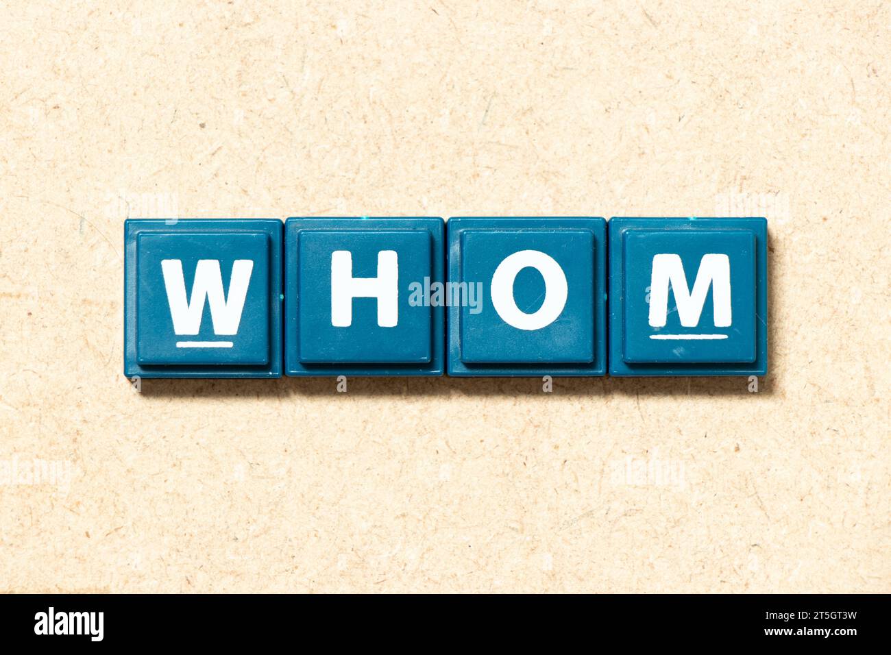 Tile alphabet letter in word whom on wood background Stock Photo - Alamy