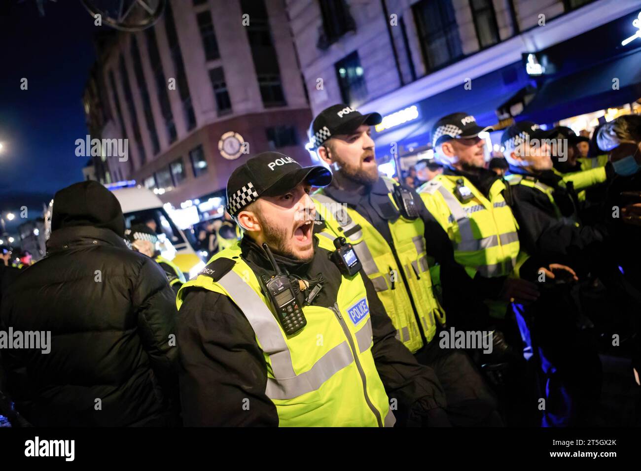 Police push demonstrators back as they attempt to prevent police vans ...