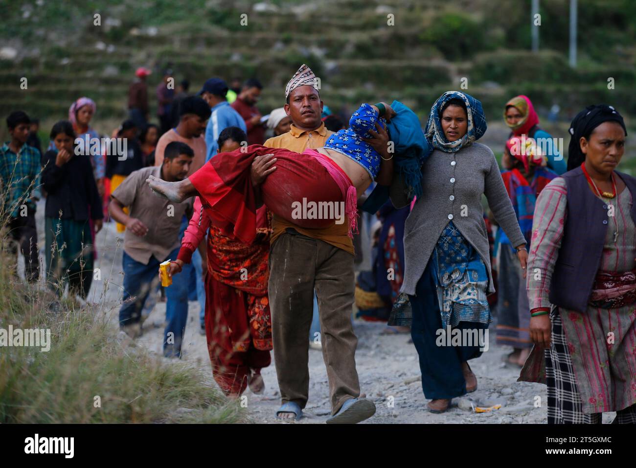 Rukum, Nepal. 5th Nov, 2023. A woman faints and is taken towards an ...