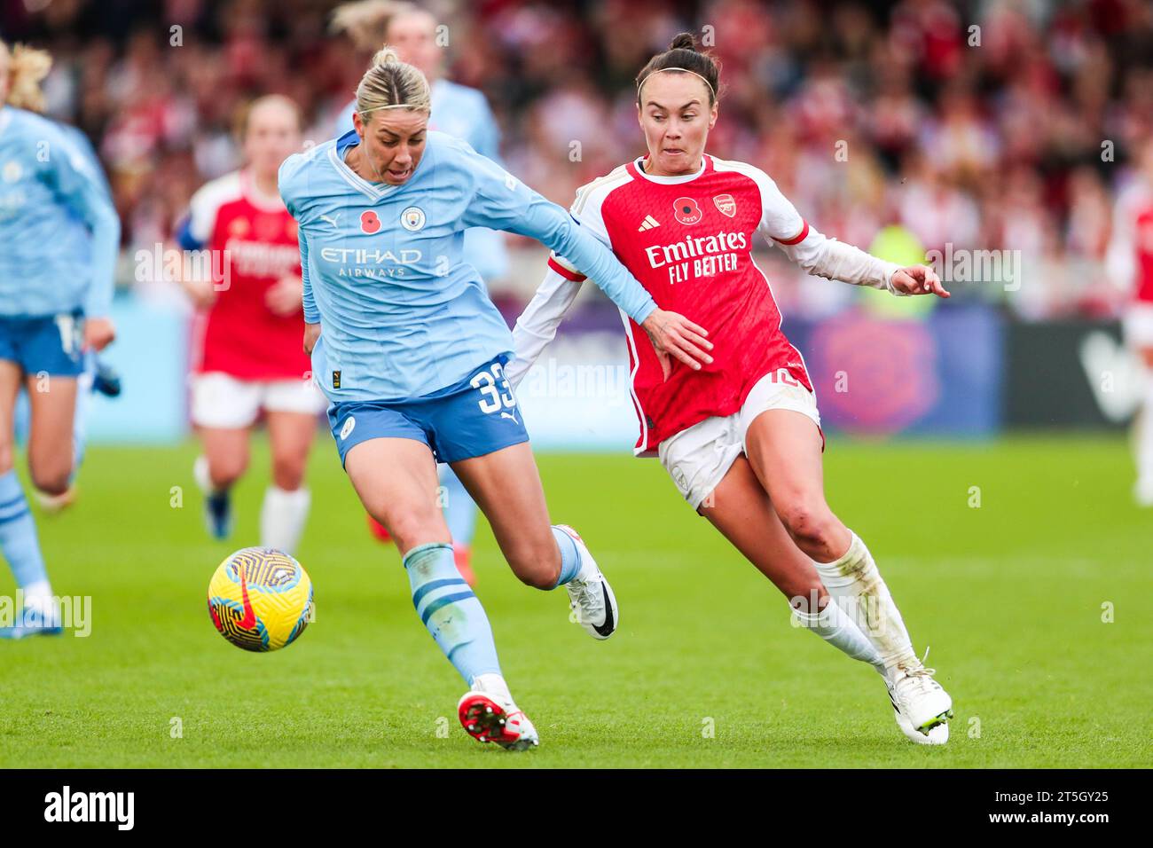 Manchester City's Alanna Kennedy battles for the ball against Arsenal's ...