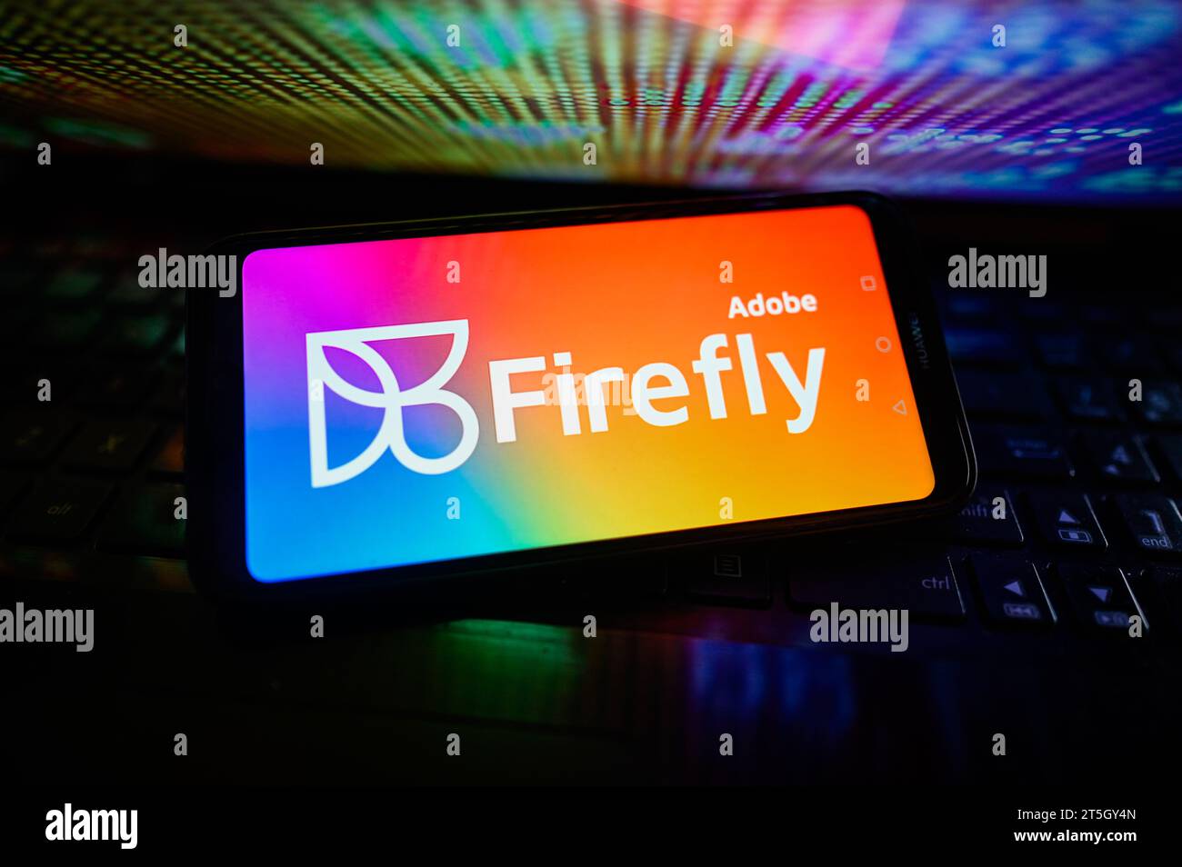 In this photo illustration an Adobe Firefly logo is displayed on a ...