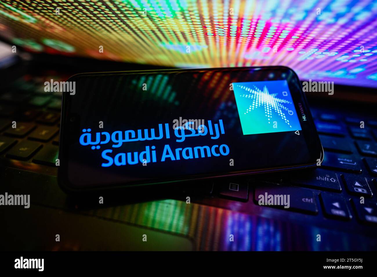 In this photo illustration a Saudi Aramco logo is displayed on a ...