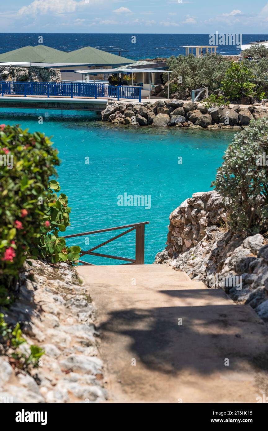 A view of the Caribbean sea, glimpsed at the bottom of a path way ...