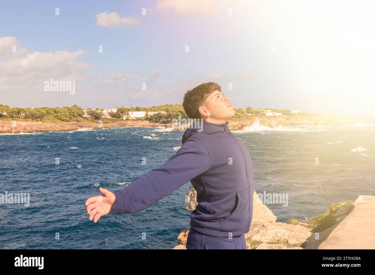 young hispanic with open arms praying to jesus, receiving spiritual ...