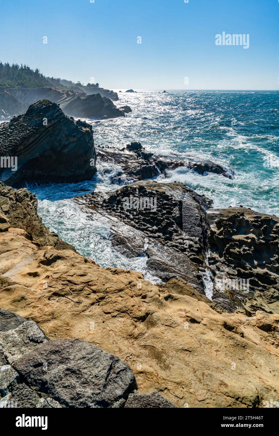 A view of the shoreline with rock formations and crashing waves at ...