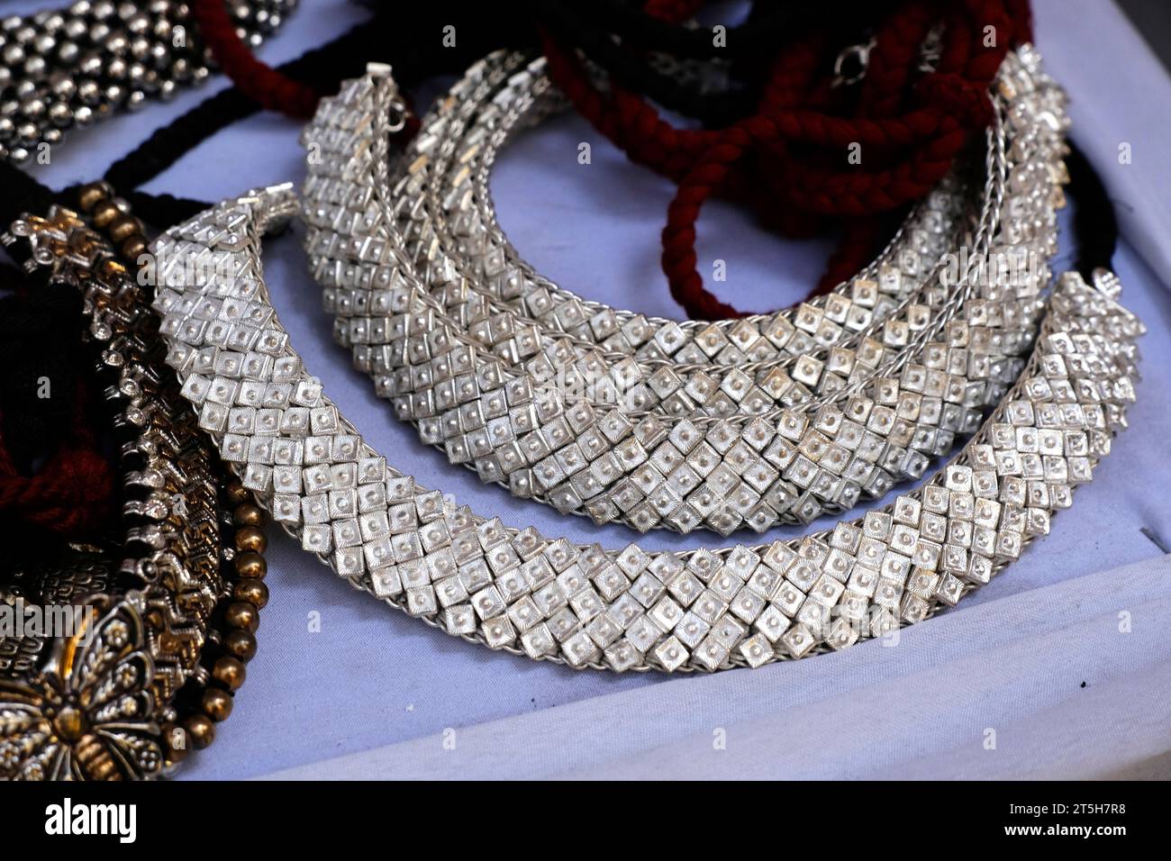colorful traditional indian jewelry displayed in a street shop for sale ...