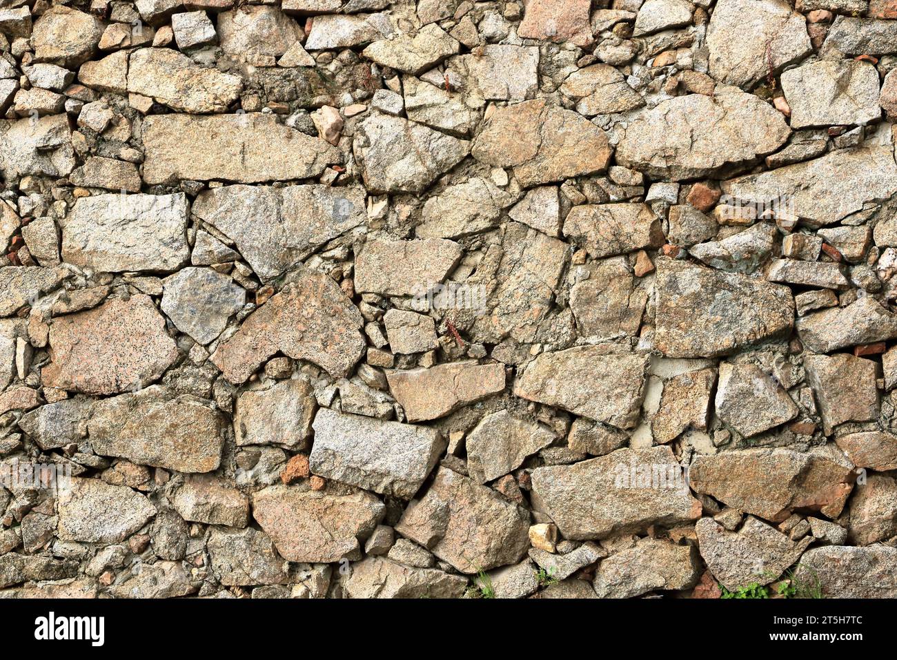 yellow beige natural stone wall of different sized stones, traditional ...