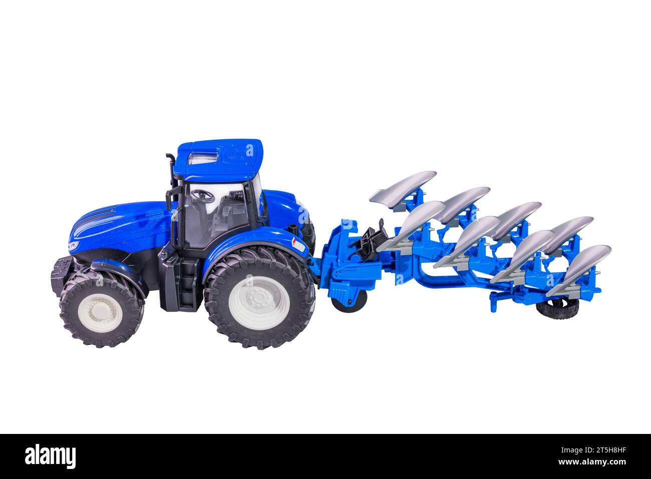 Isolated view of radio-controlled toy farm tractor model with plow on ...