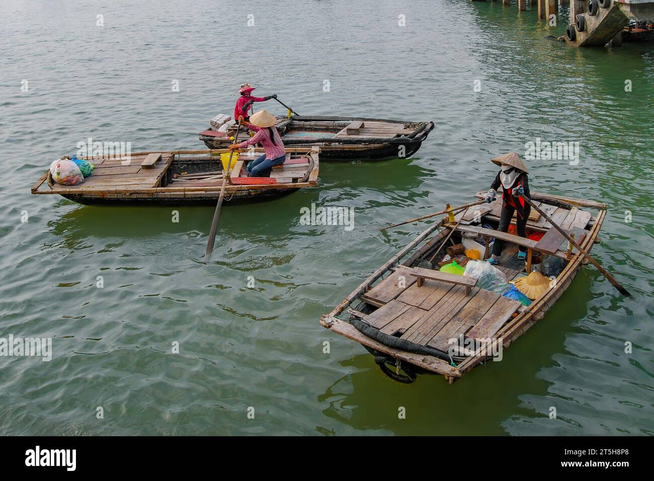 Three wooden boats with boatmen from Halong Bay. Vietnam Stock Photo ...