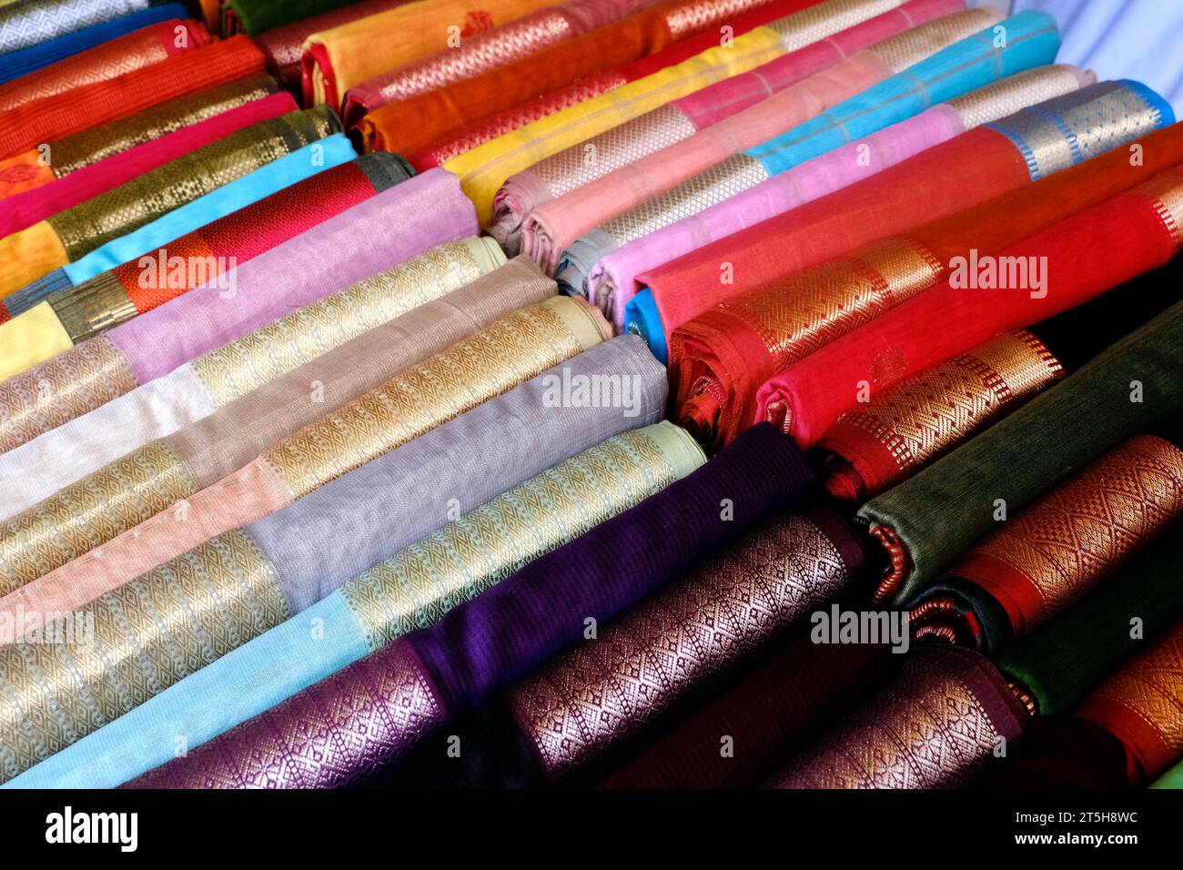 Fancy Indian sarees, Neatly stacked colorful silk saris in racks in a ...
