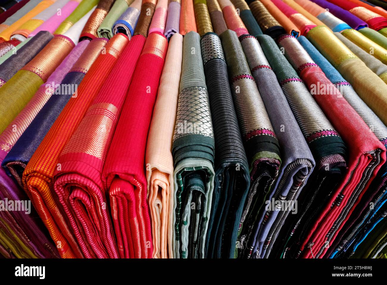 Fancy Indian sarees, Neatly stacked colorful silk saris in racks in a ...