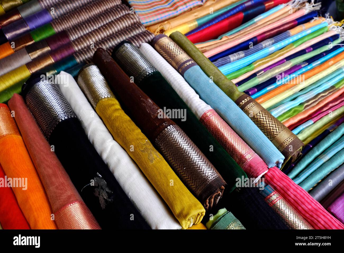 Fancy Indian sarees, Neatly stacked colorful silk saris in racks in a ...