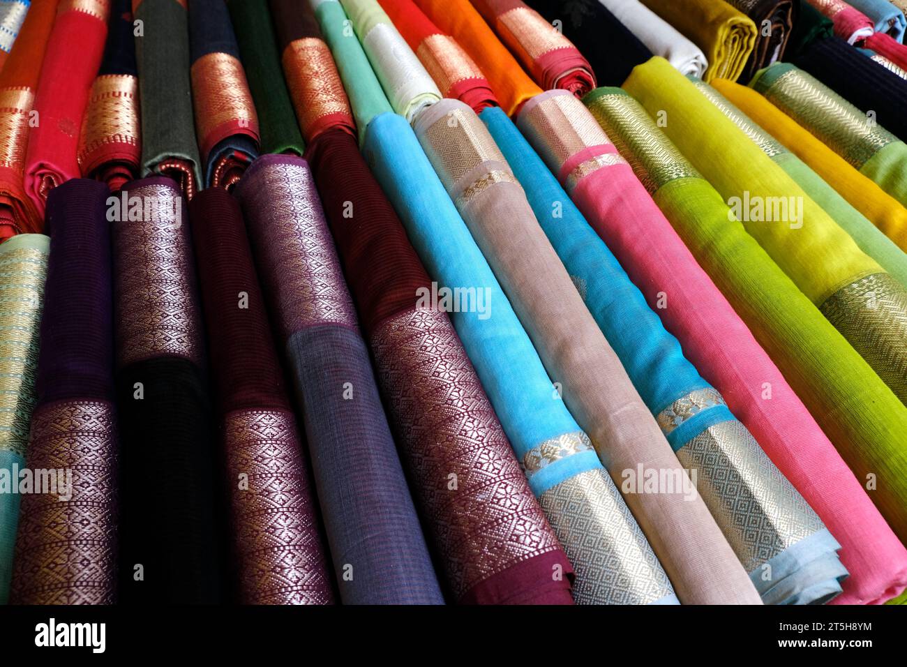 Fancy Indian sarees, Neatly stacked colorful silk saris in racks in a ...