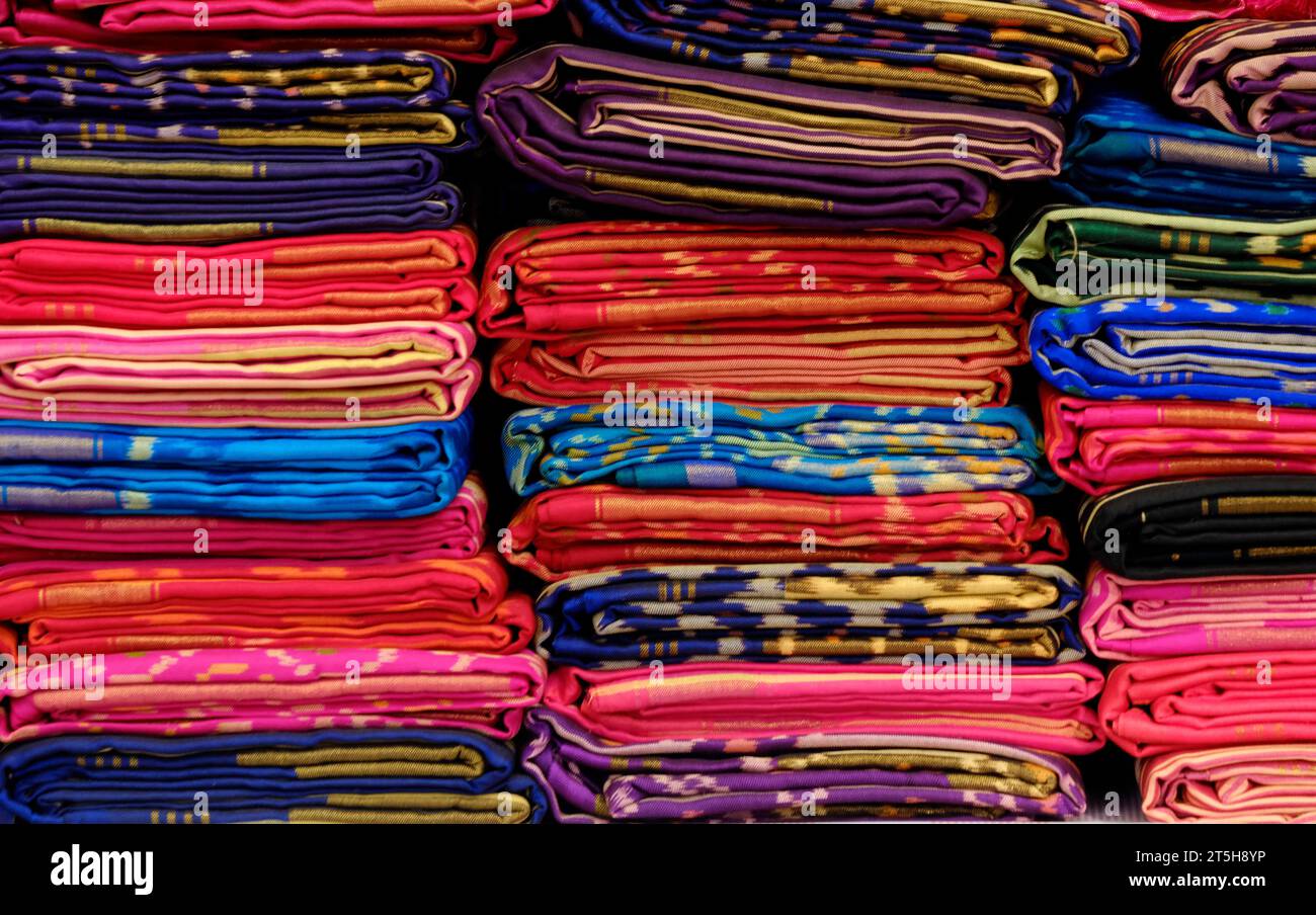 Fancy Indian sarees, Neatly stacked colorful silk saris in racks in a ...