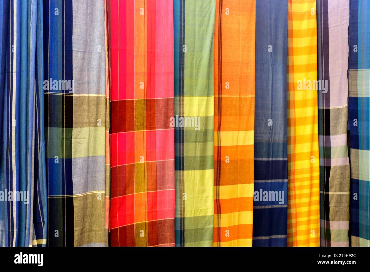 Fancy Indian sarees, Neatly stacked colorful silk saris in racks in a ...