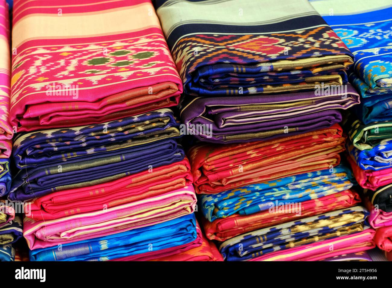 Fancy Indian sarees, Neatly stacked colorful silk saris in racks in a ...