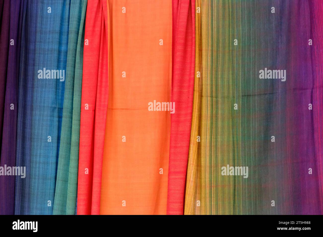 Fancy Indian sarees, Neatly stacked colorful silk saris in racks in a ...