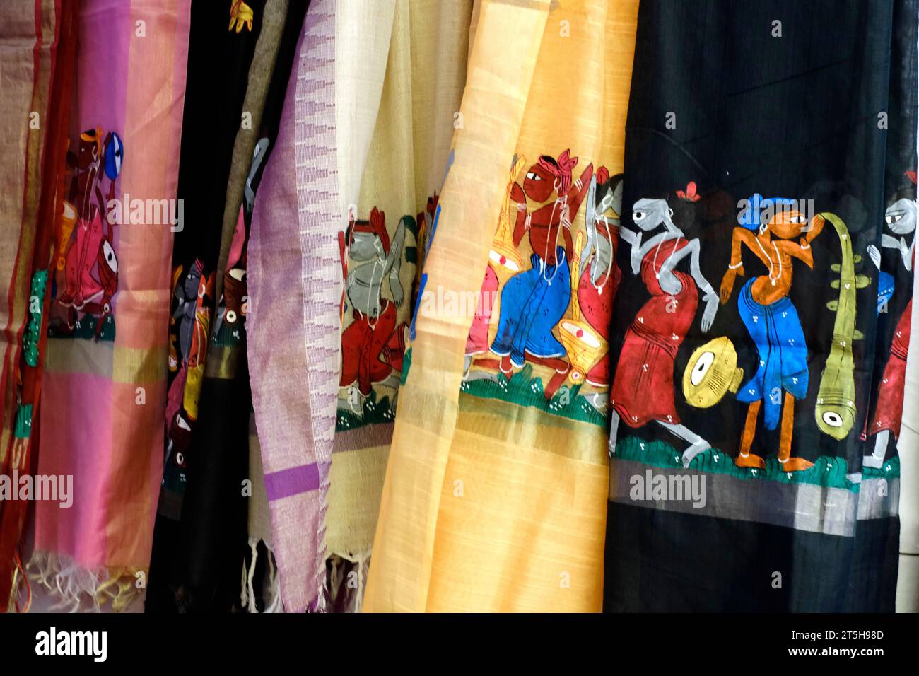 Fancy Indian sarees, Neatly stacked colorful silk saris in racks in a ...