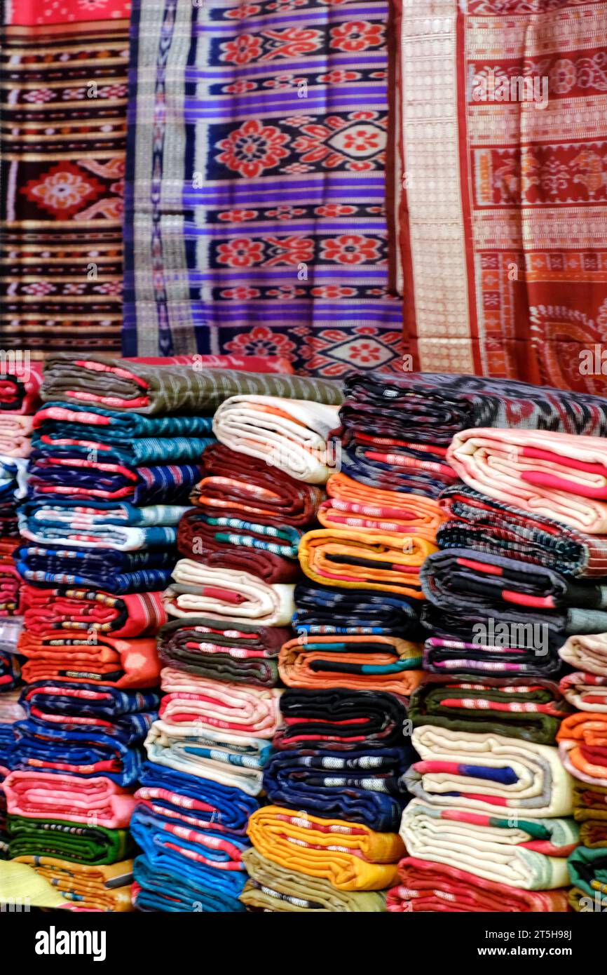 Fancy Indian sarees, Neatly stacked colorful silk saris in racks in a ...