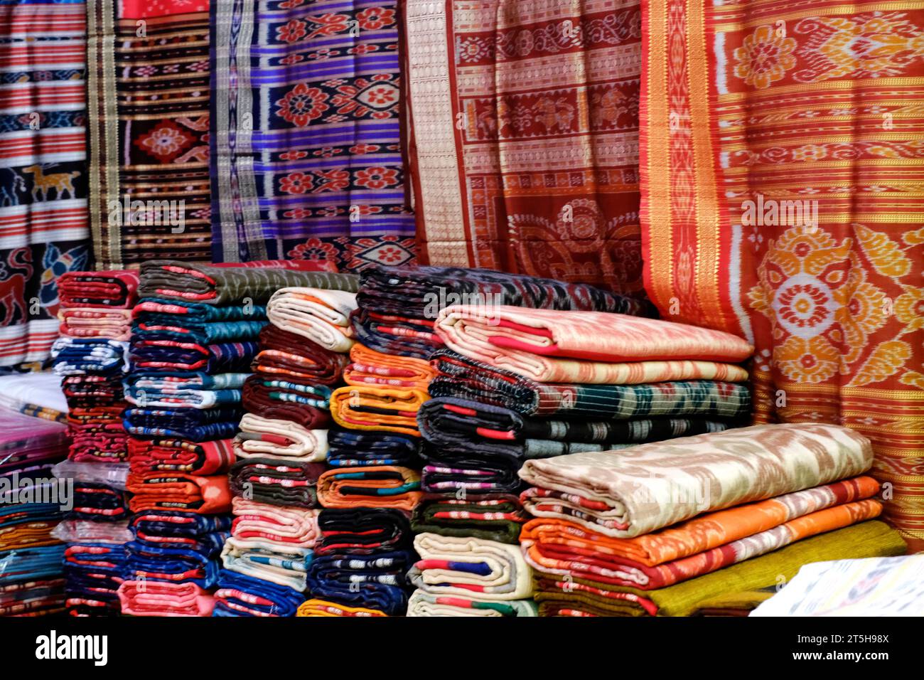 Fancy Indian sarees, Neatly stacked colorful silk saris in racks in a ...