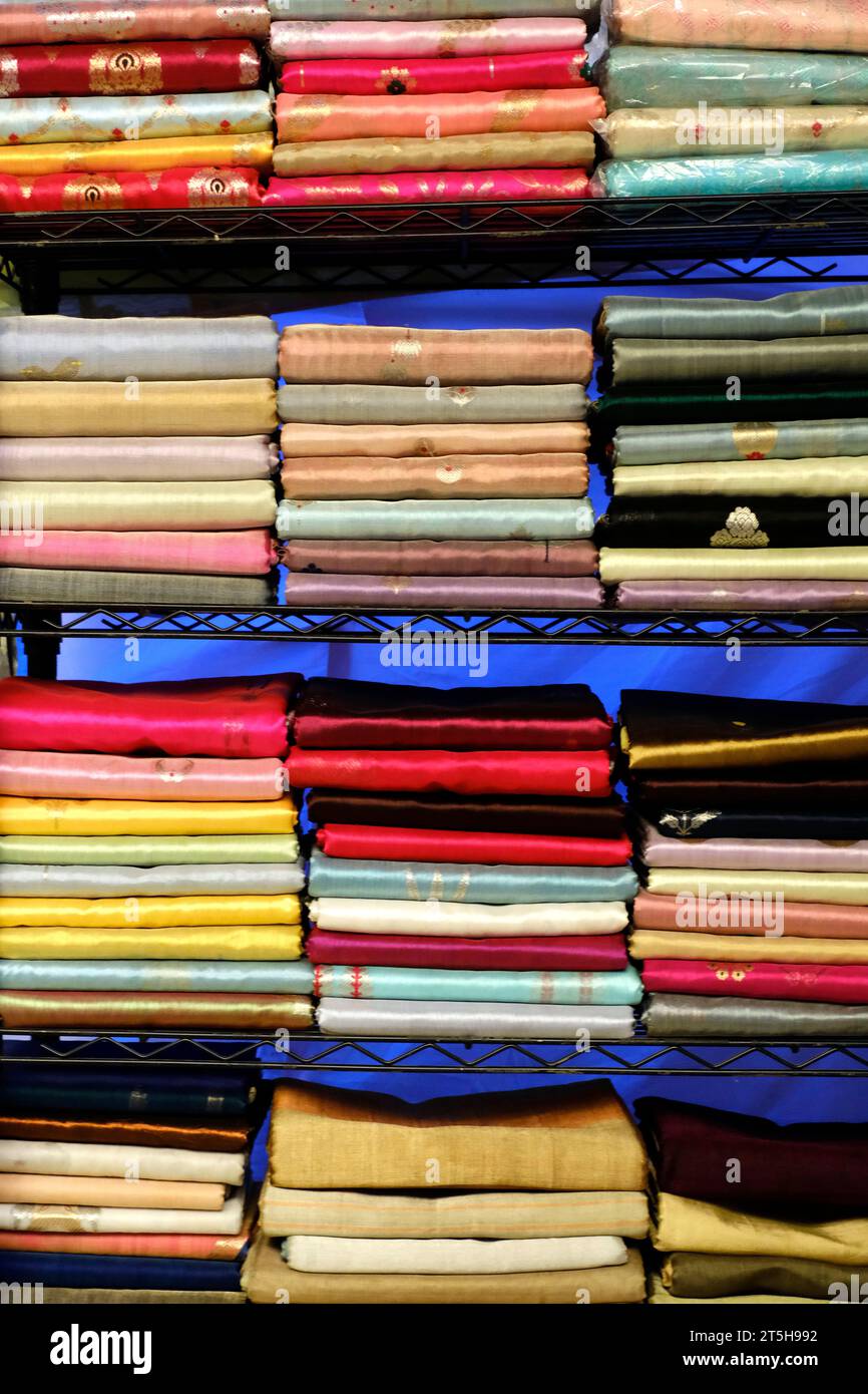 Fancy Indian sarees, Neatly stacked colorful silk saris in racks in a ...