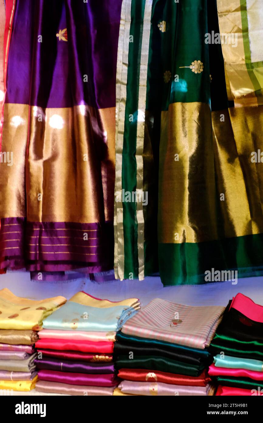 Fancy Indian sarees, Neatly stacked colorful silk saris in racks in a ...