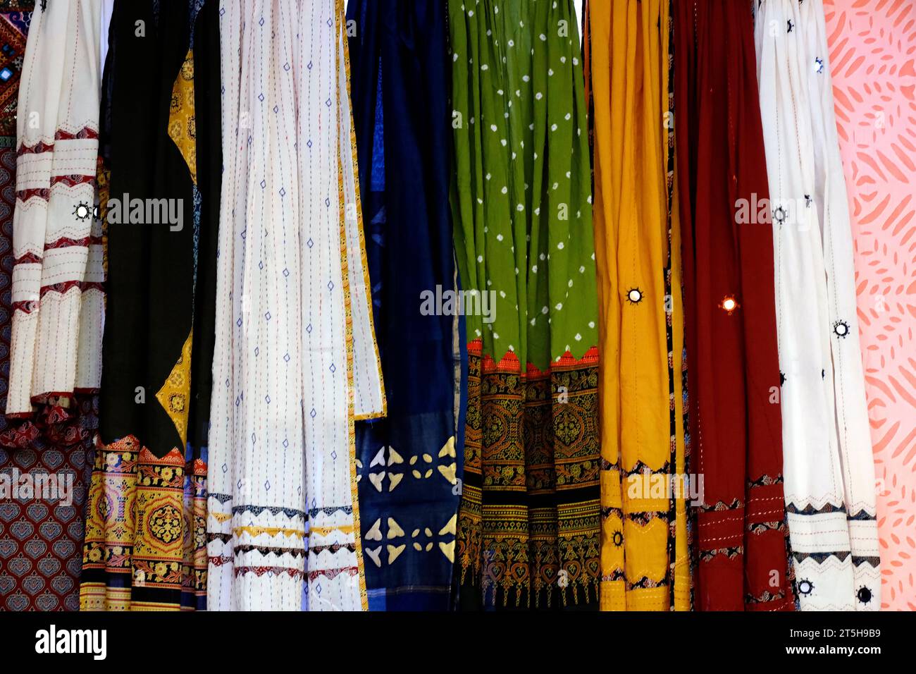 Fancy Indian sarees, Neatly stacked colorful silk saris in racks in a ...