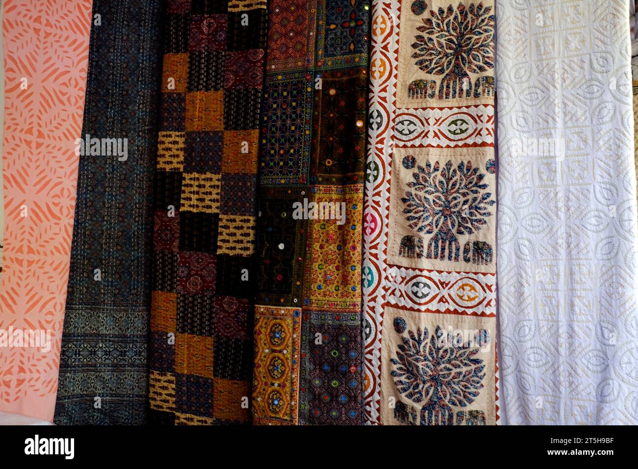 Fancy Indian sarees, Neatly stacked colorful silk saris in racks in a ...