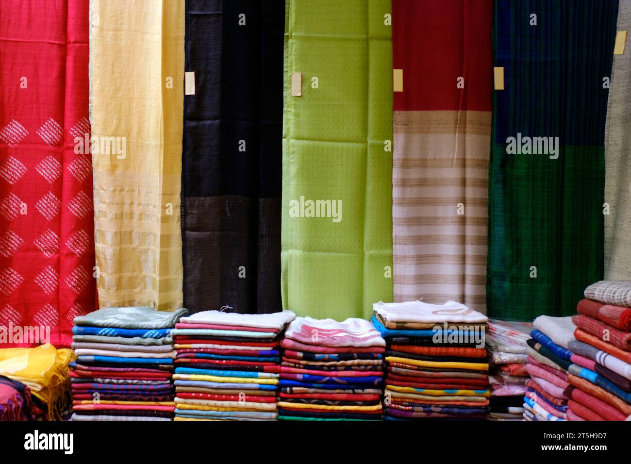 Fancy Indian sarees, Neatly stacked colorful silk saris in racks in a ...
