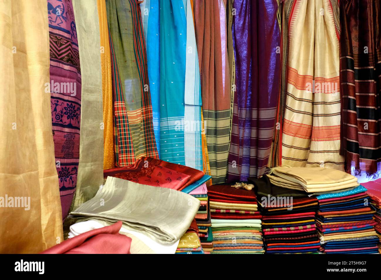 Fancy Indian sarees, Neatly stacked colorful silk saris in racks in a ...