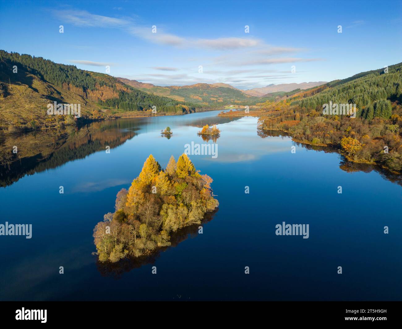 Aerial view of tree covered island in autumn colours on Loch Chon ...