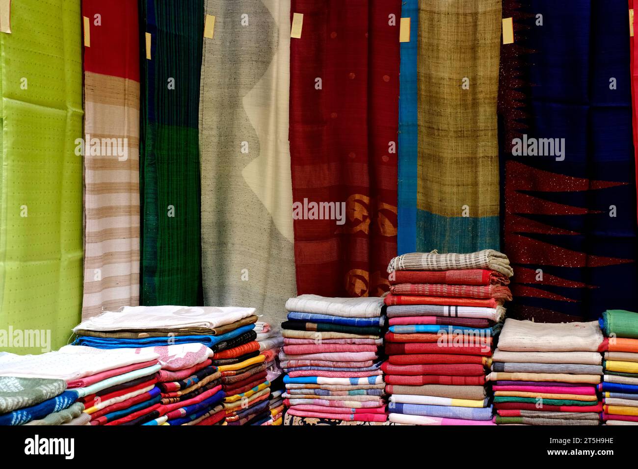 Fancy Indian sarees, Neatly stacked colorful silk saris in racks in a ...