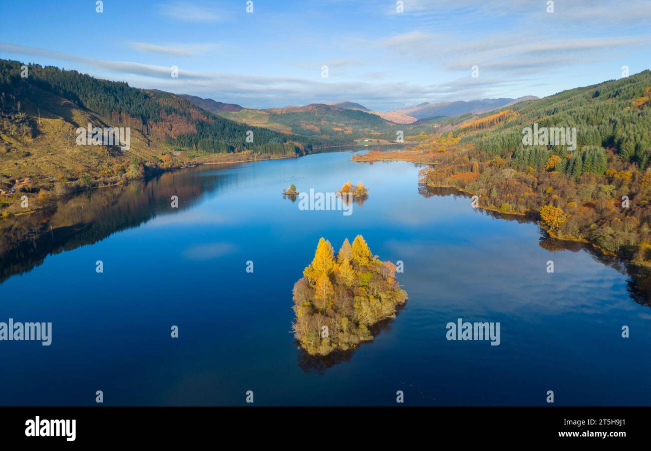 Aerial view of tree covered island in autumn colours on Loch Chon ...