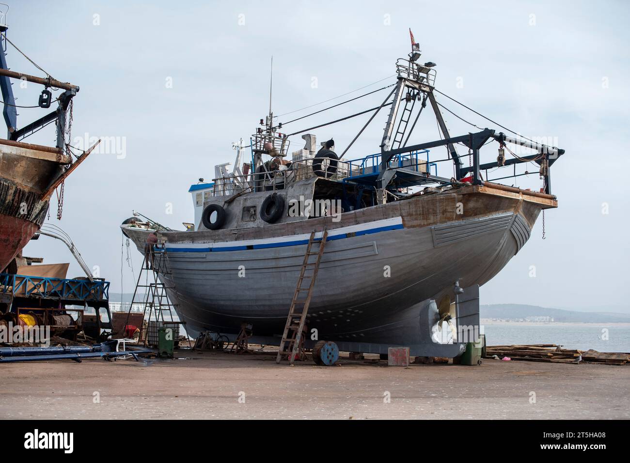 Large wooden fishing boats being repaired in the port Essaouira Morocco ...
