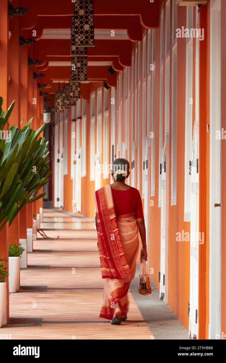 An Asian Lady Walking Along A Saffron Coloured Walkway Dressed In A ...