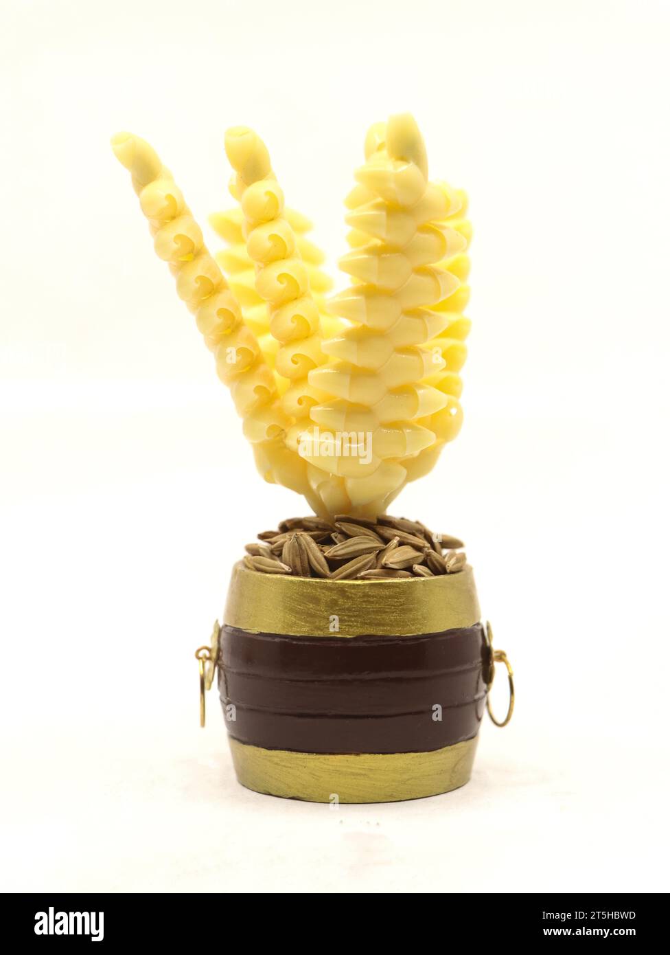 an offering to god with coconut flower in a vessel filled with wheat ...