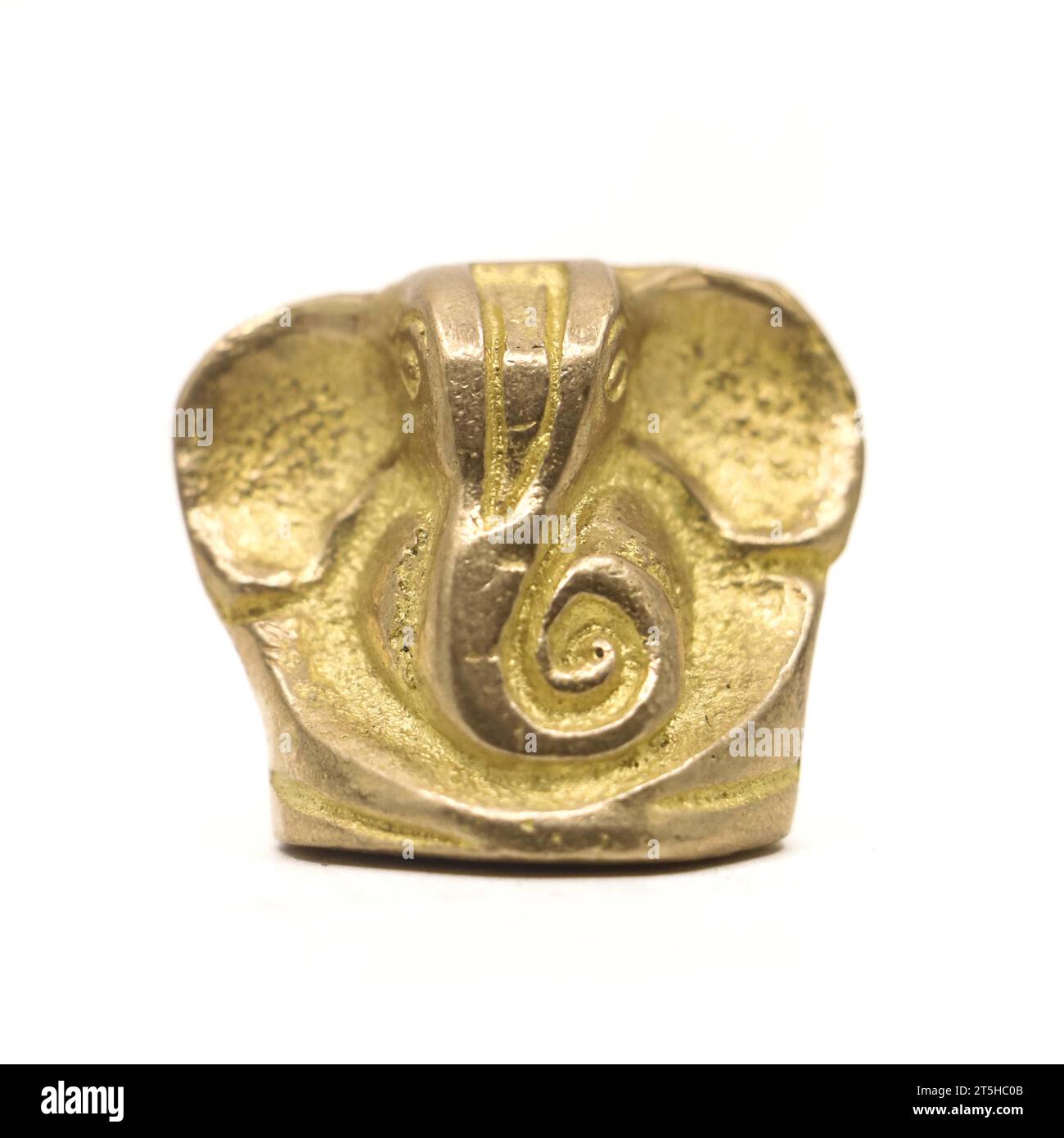 tiny lord ganesh golden statue with simple design having large ears and ...