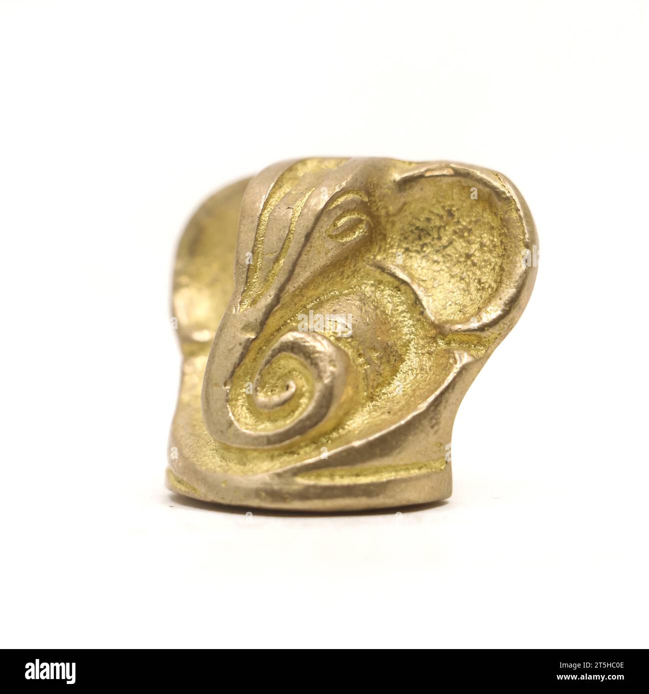 tiny lord ganesh golden statue with simple design having large ears and ...
