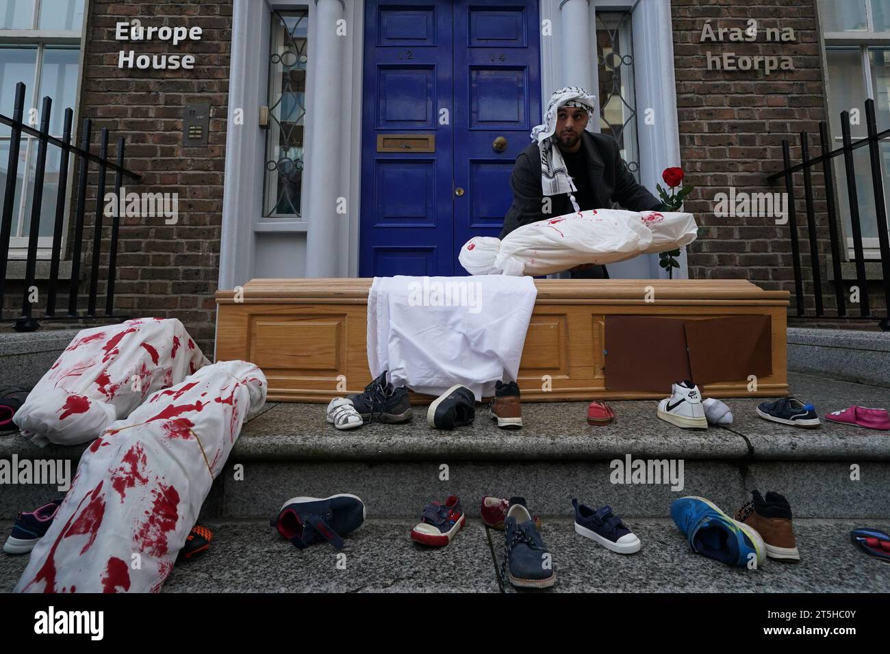 A coffin, children's shoes and effigies of dead children is placed ...