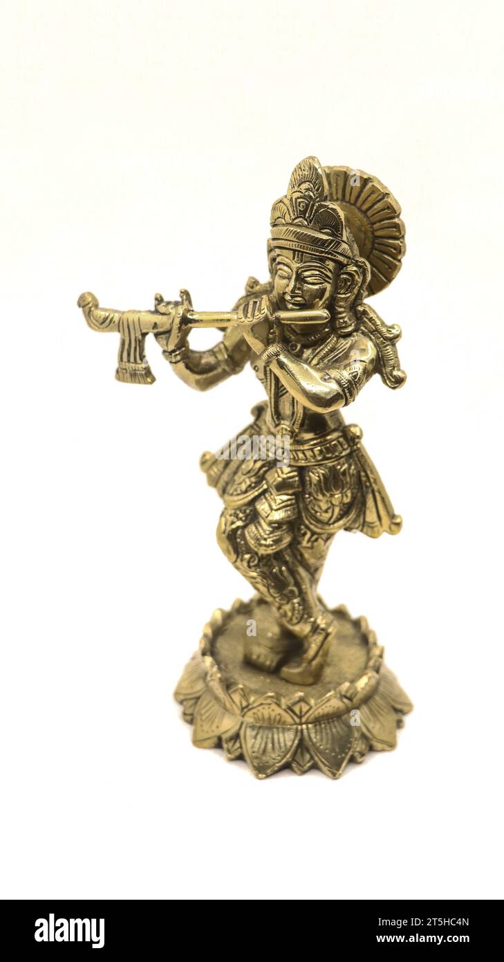 lord krishna golden idol isolated in a white background Stock Photo - Alamy