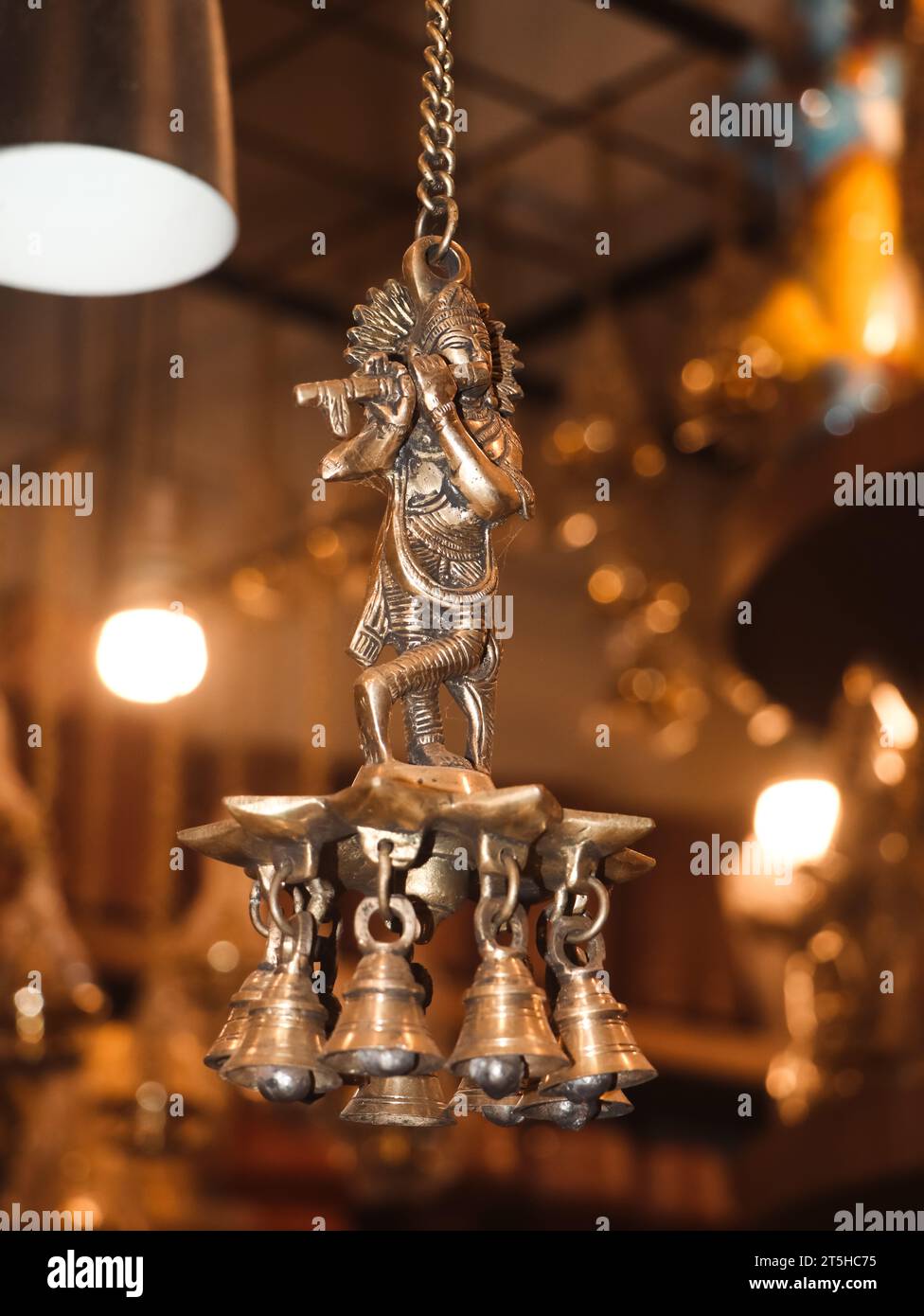 a wind chime bell with lord krishna playing flute bronze figure hanging ...