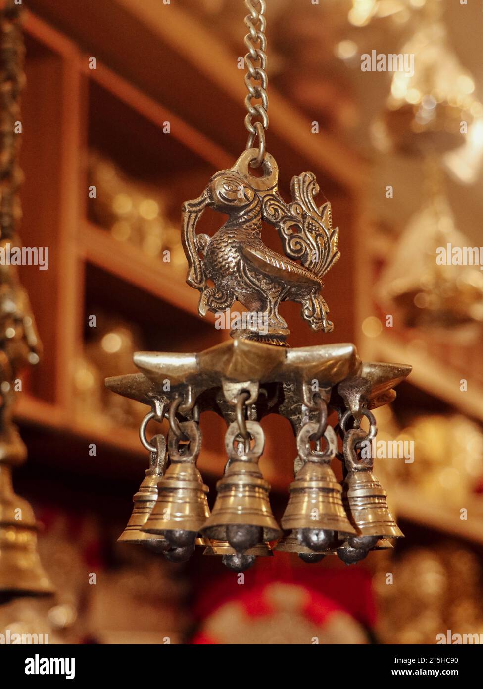 peacock wind chime bells hanging on a chain, carved in bronze inside a ...