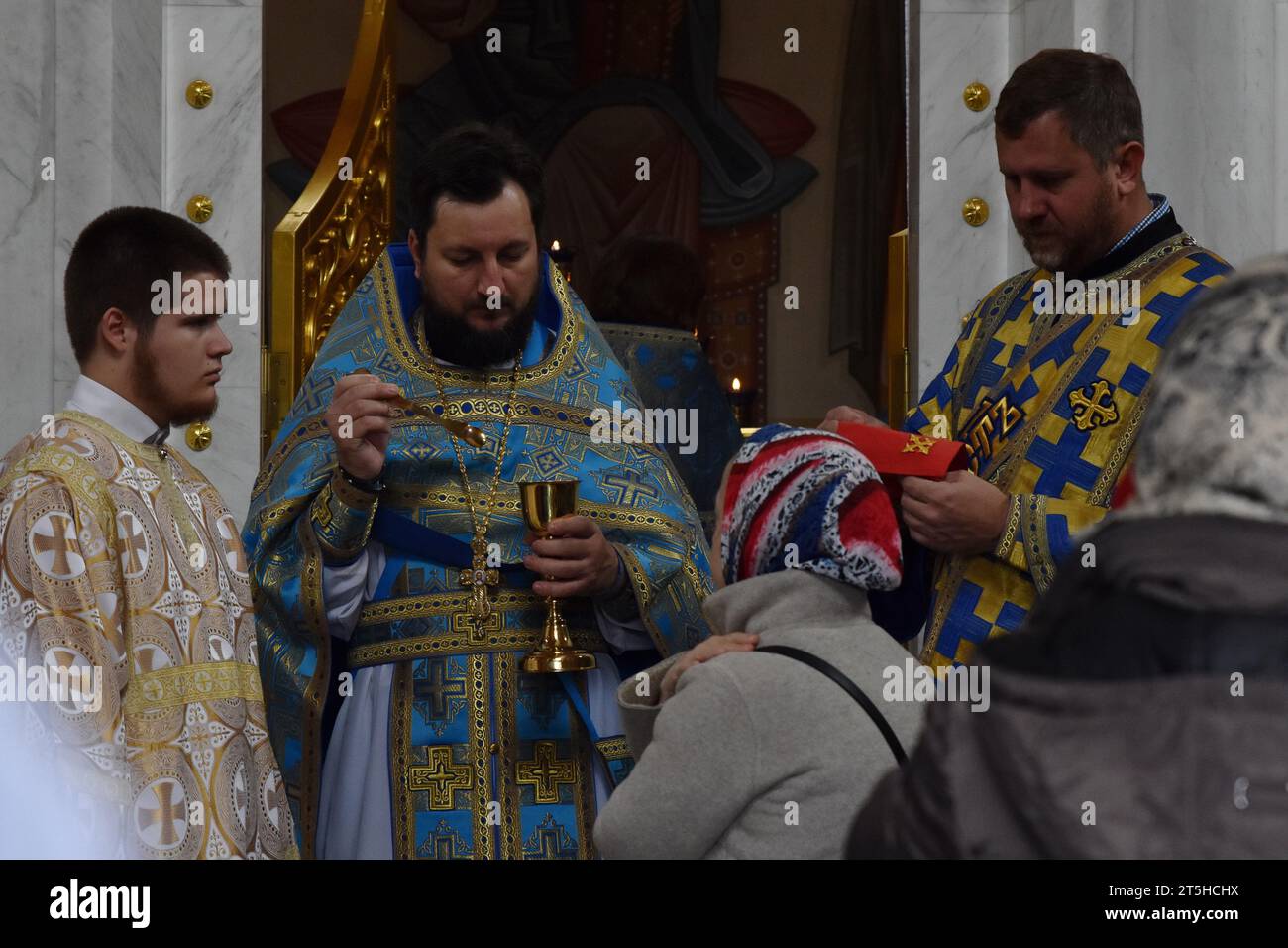 Orthodox Christian priests and believers are seen during the Eucharist ...