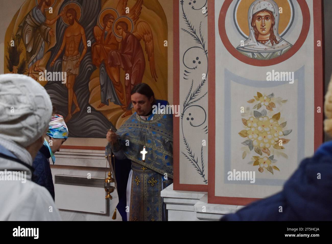 Orthodox Christian priest and believers are seen during the service ...